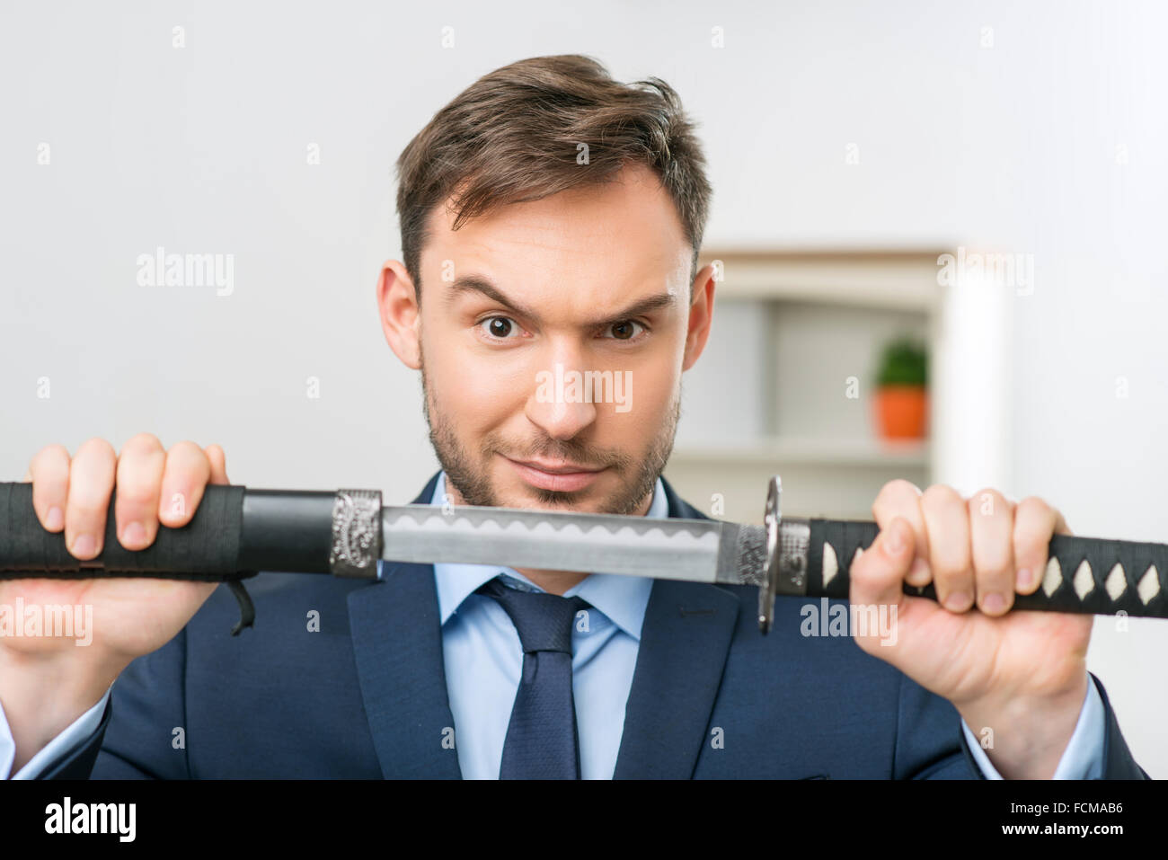 Professional office worker holding sword Stock Photo - Alamy
