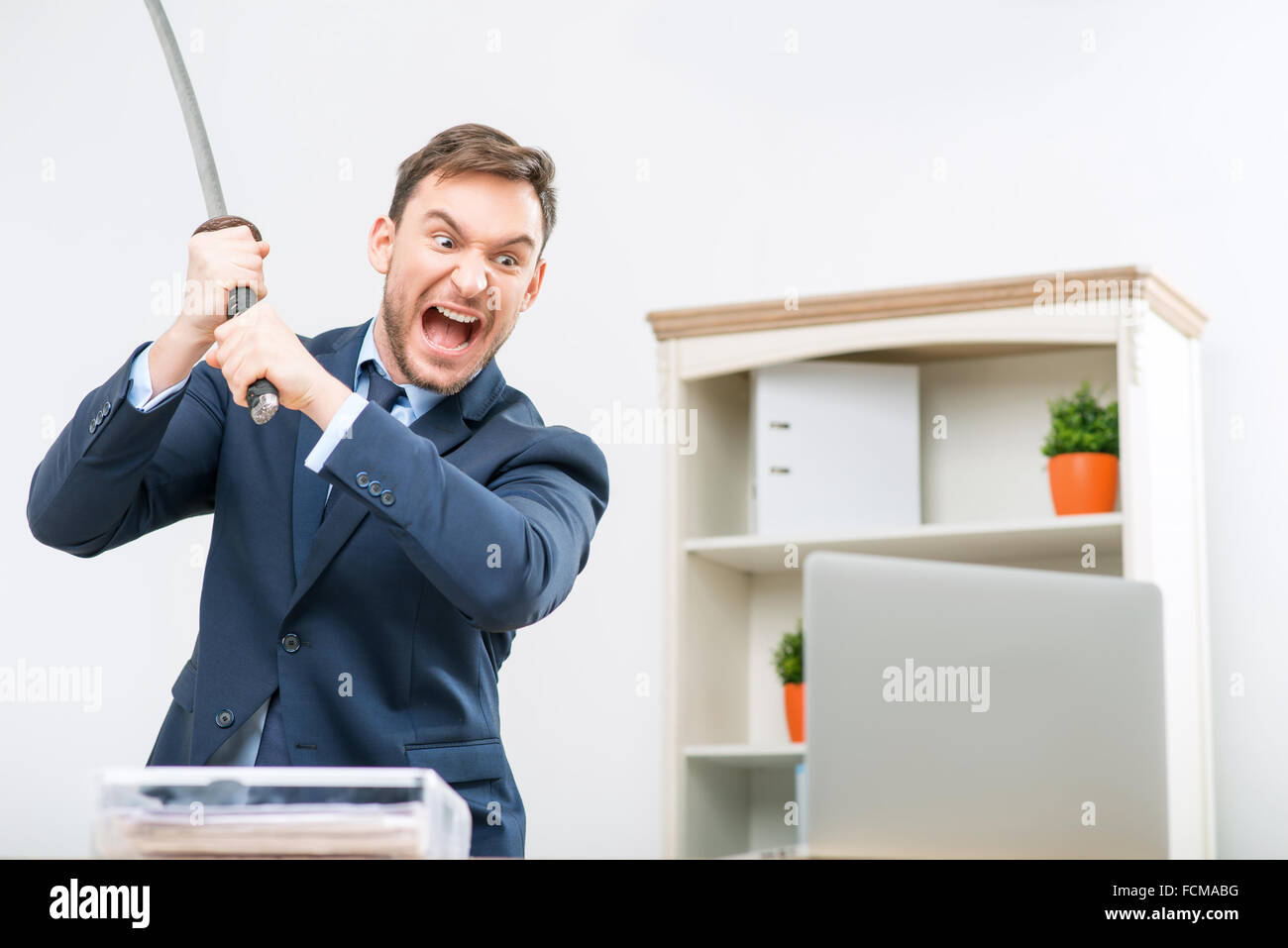 Professional office worker holding sword Stock Photo - Alamy