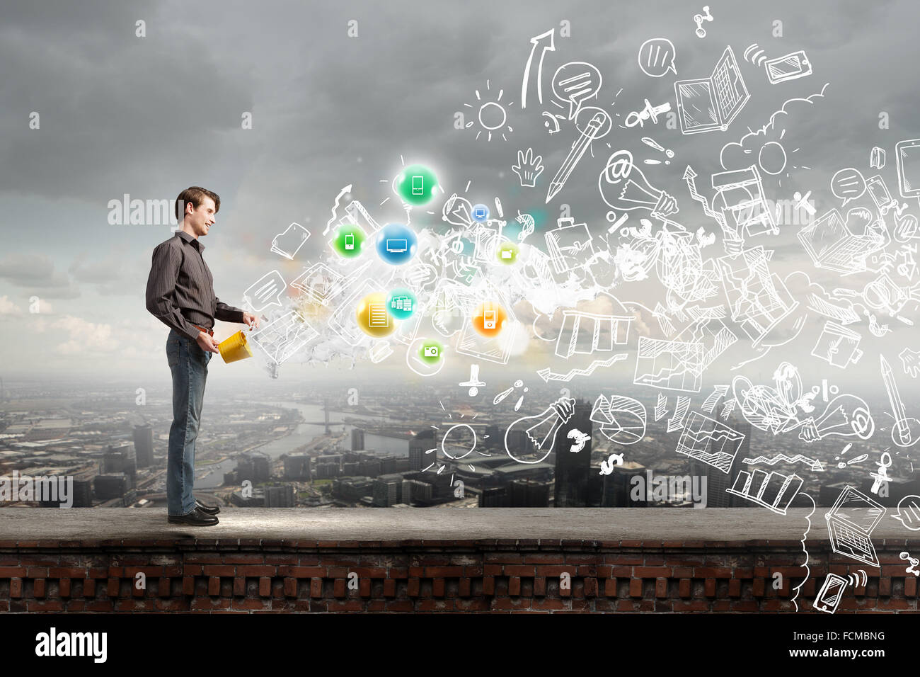 Young man in casual splashing icons from bucket Stock Photo - Alamy