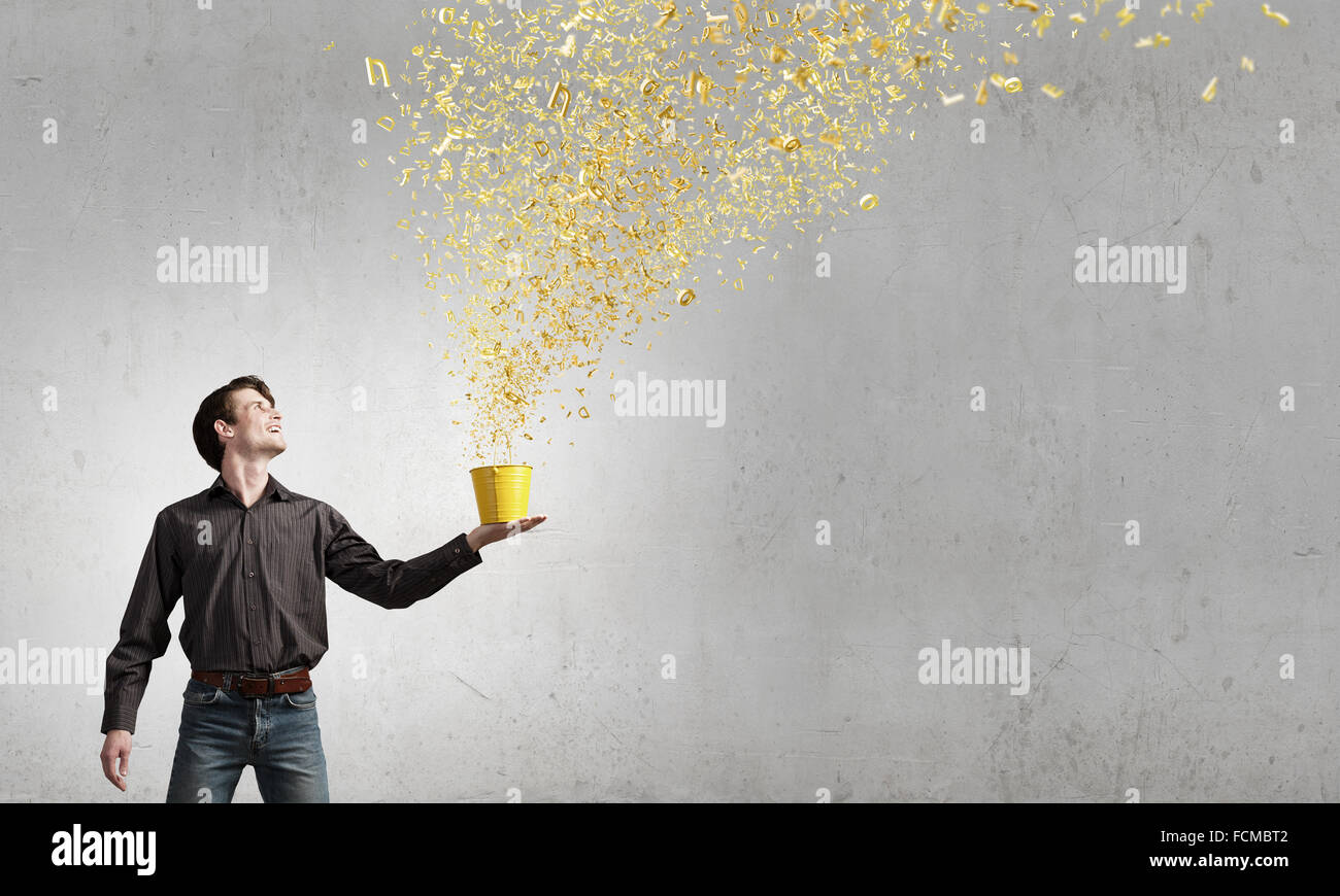 Young man in casual splashing characters from bucket Stock Photo - Alamy