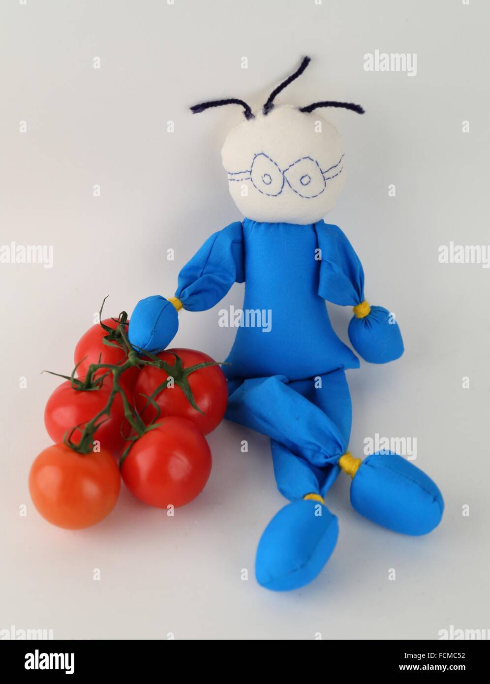 Puppet laying next to some tomatoes Stock Photo - Alamy