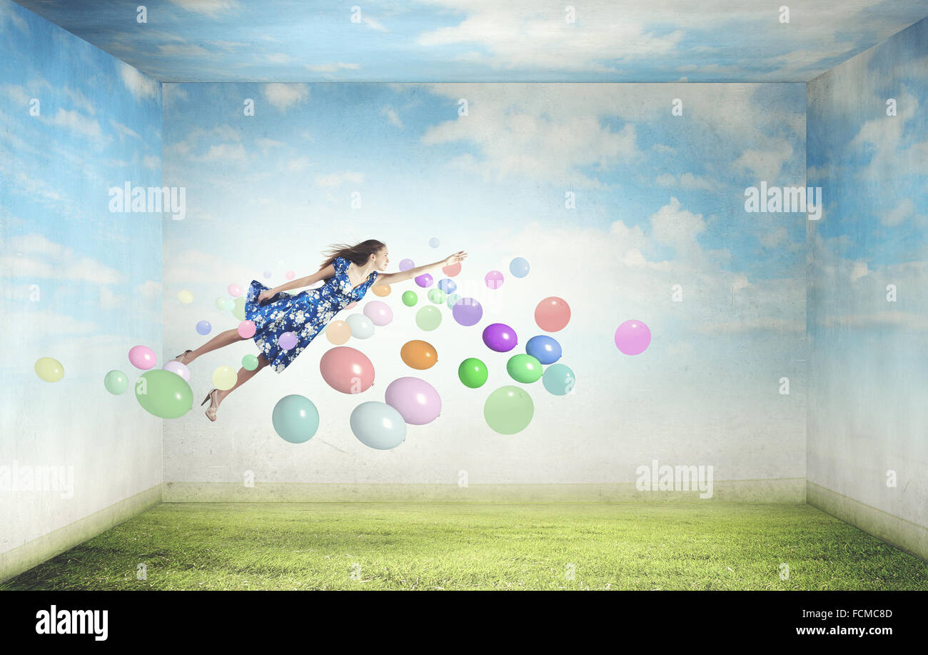 Young woman in summer dress flying in sky Stock Photo - Alamy