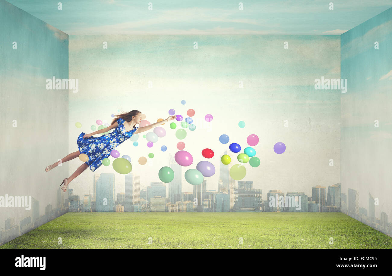 Young woman in summer dress flying in sky Stock Photo - Alamy