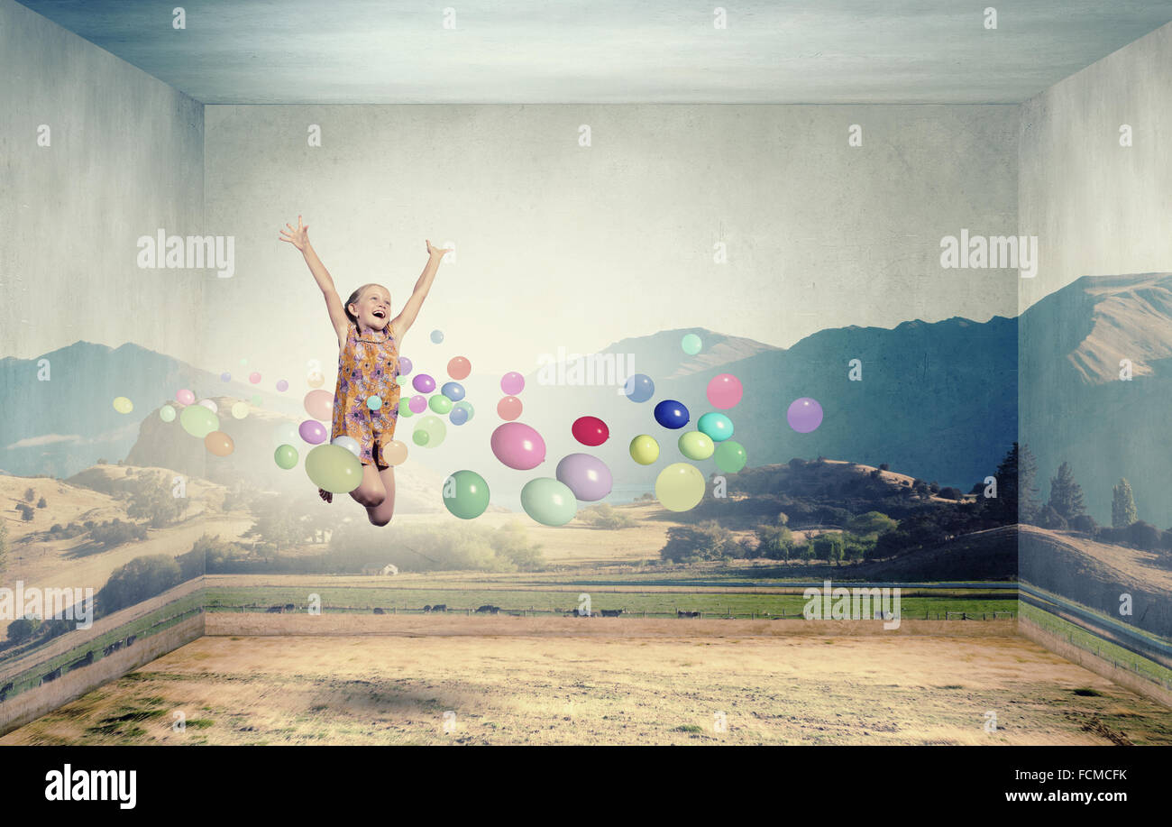 Little cute girl jumping high among balloons flying in sky Stock Photo ...