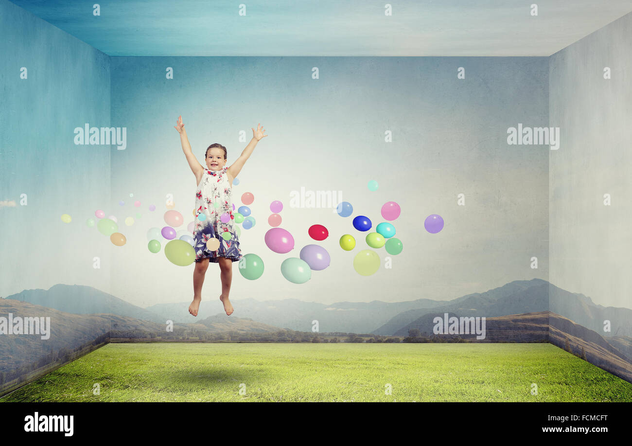 Little cute girl jumping high among balloons flying in sky Stock Photo ...