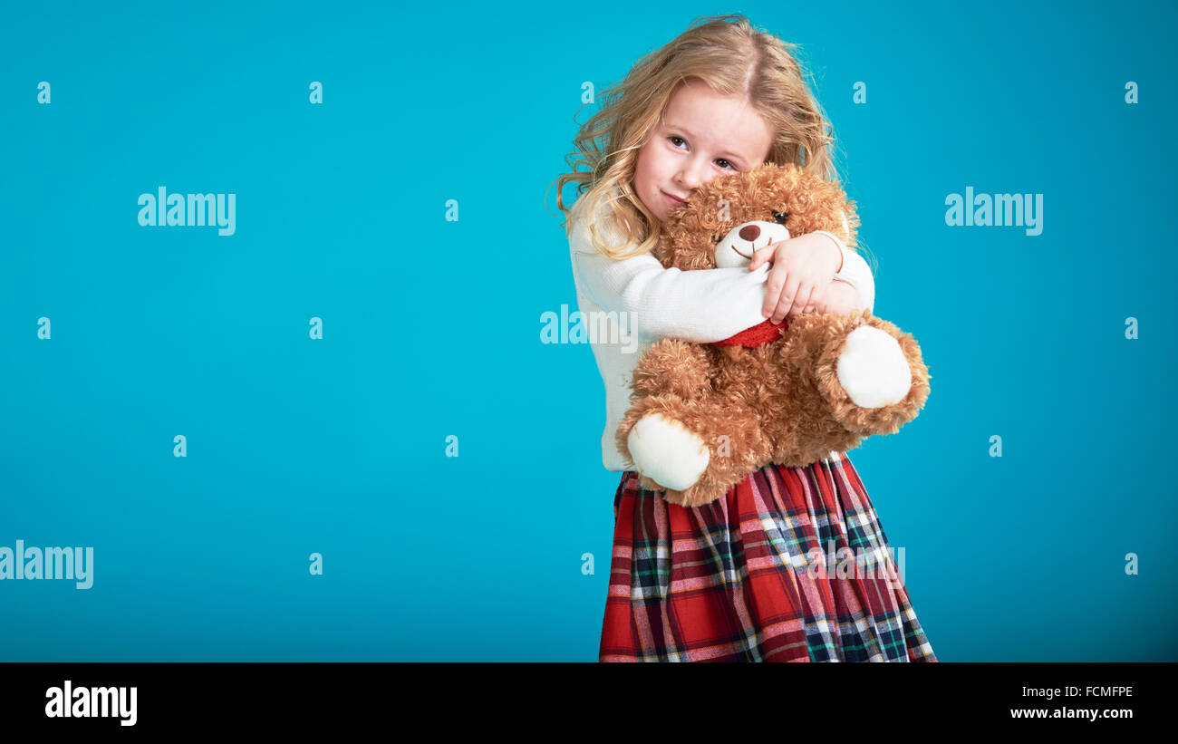 Fabulous little girl hugging brown teddy bear Stock Photo - Alamy