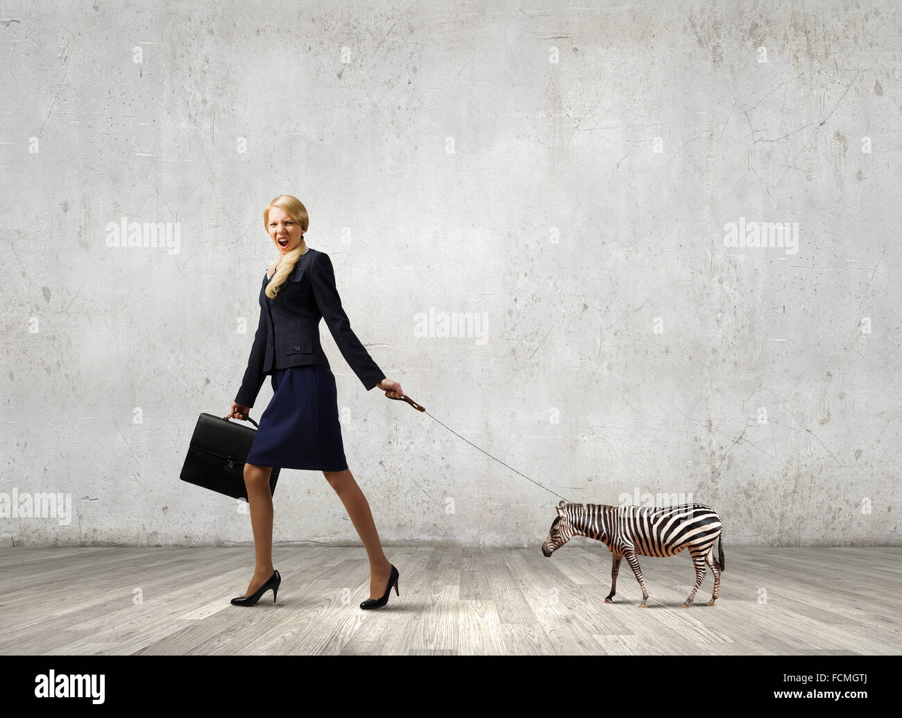 Young pretty businesswoman holding zebra on lead Stock Photo - Alamy