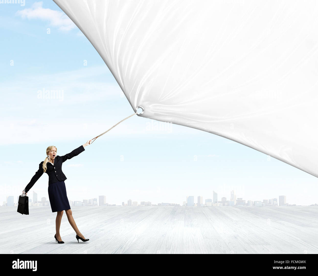Young businesswoman pulling white banner with lead Stock Photo - Alamy