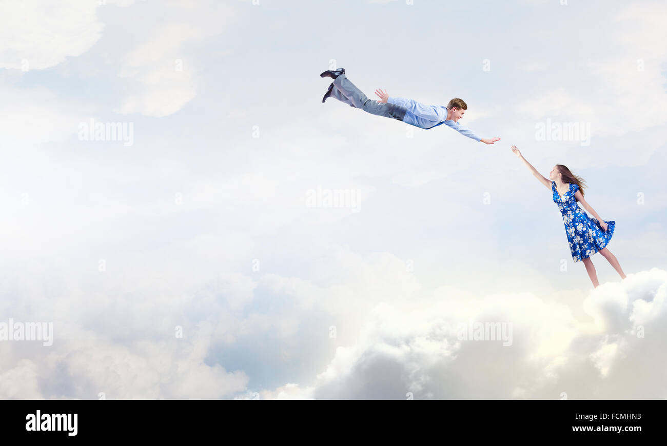 Young elegant woman trying to reach man Stock Photo - Alamy