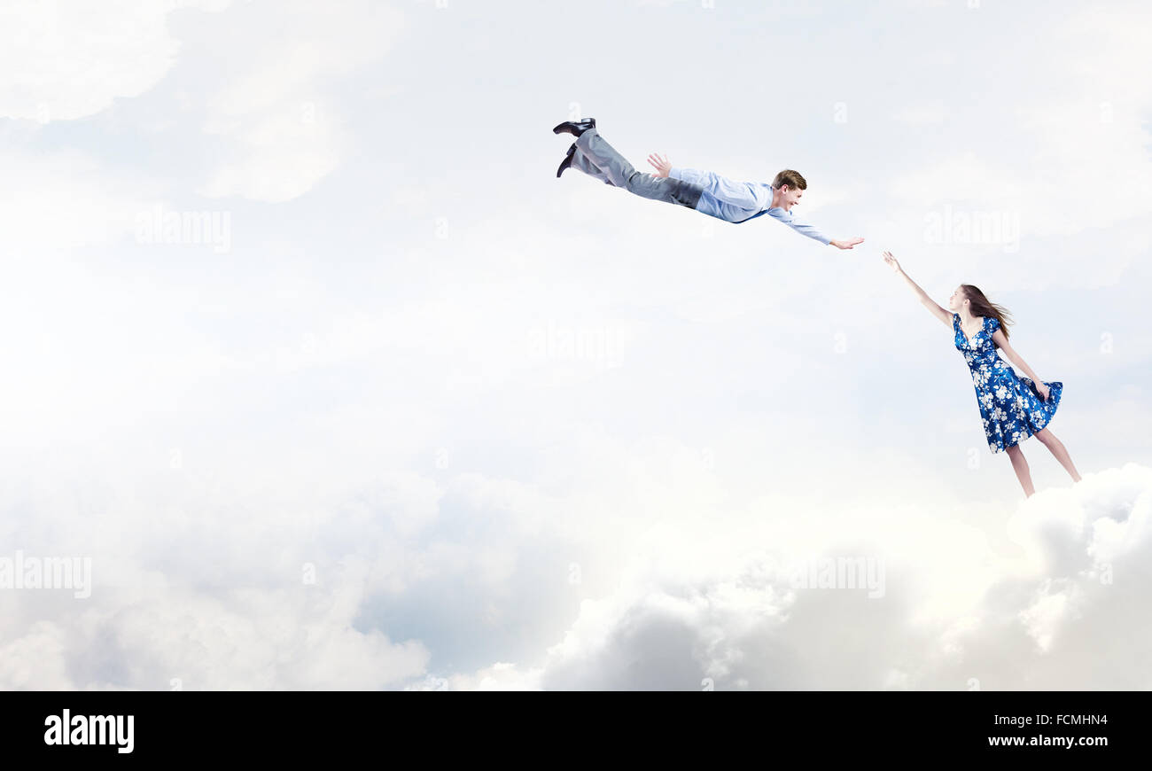 Young elegant woman trying to reach man Stock Photo - Alamy