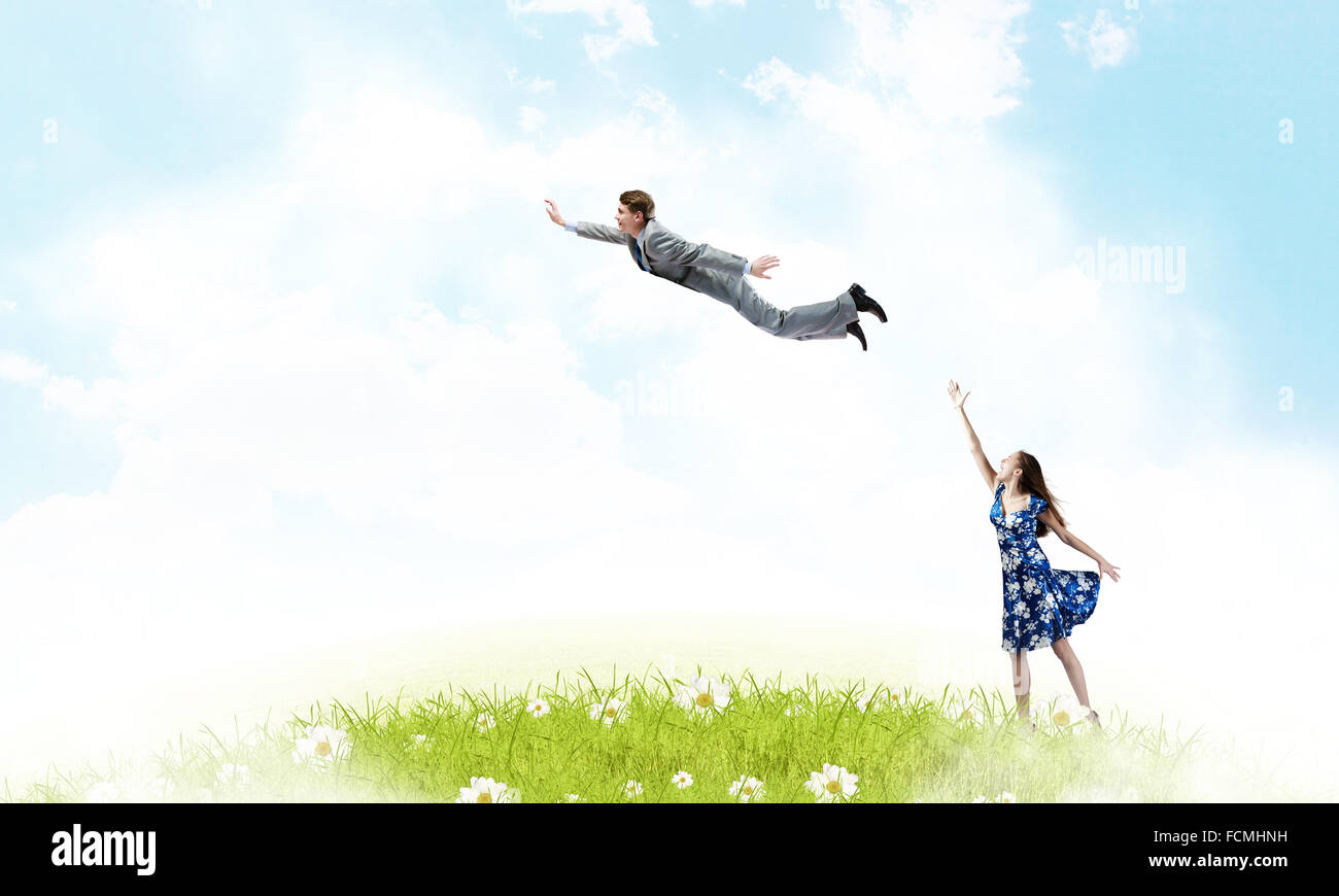 Young elegant woman trying to reach man Stock Photo - Alamy