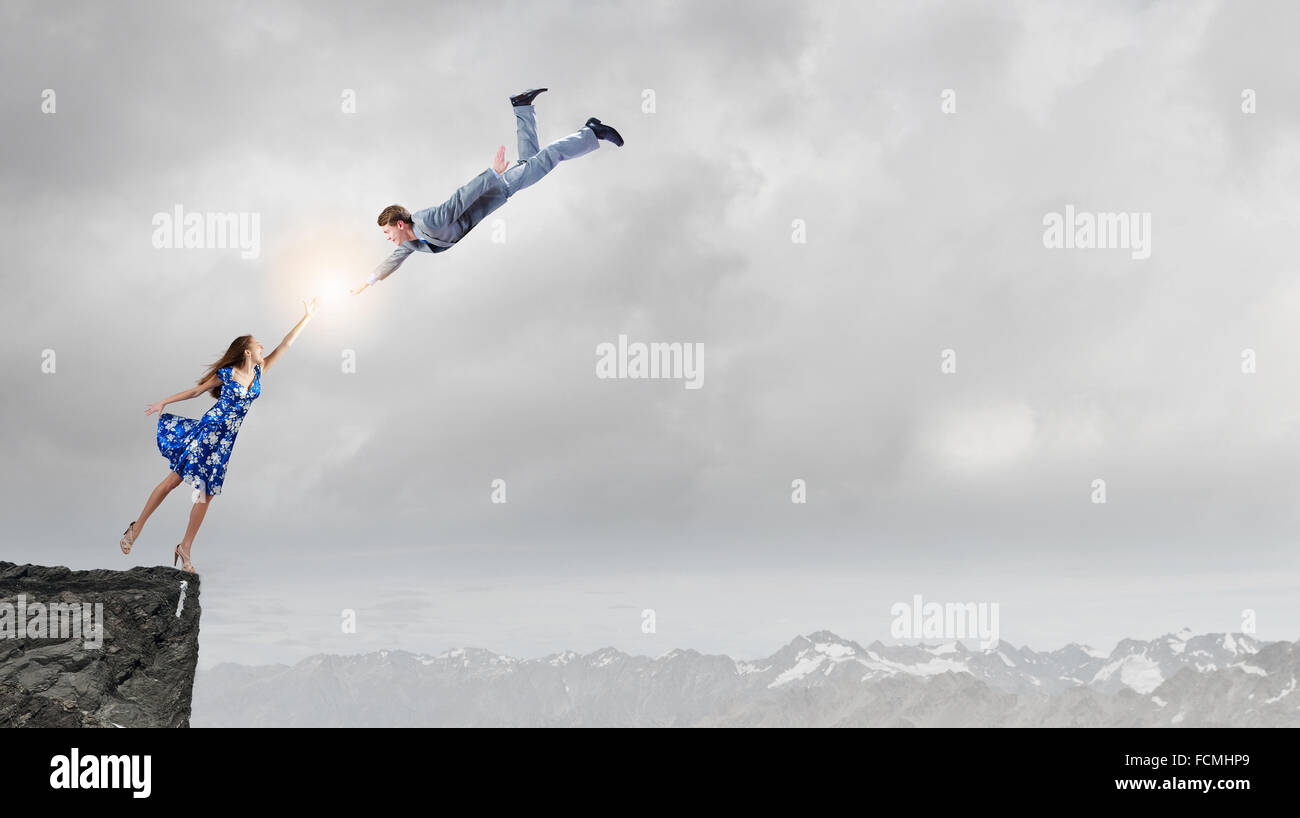 Young elegant woman trying to reach man Stock Photo - Alamy