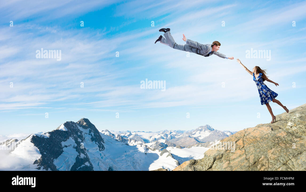 Young elegant woman trying to reach man Stock Photo - Alamy