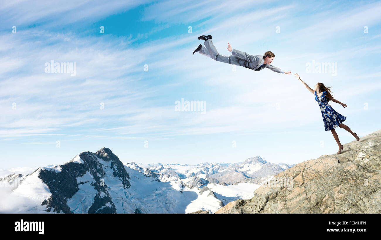 Young elegant woman trying to reach man Stock Photo - Alamy