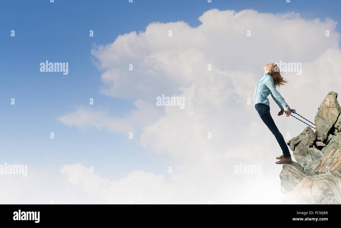 Young girl with ropes on hands trying to fly Stock Photo - Alamy