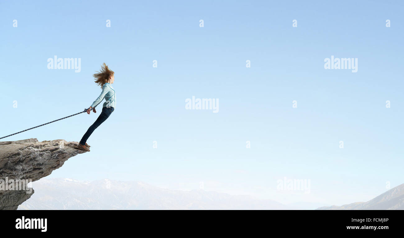 Young girl with ropes on hands trying to fly Stock Photo - Alamy