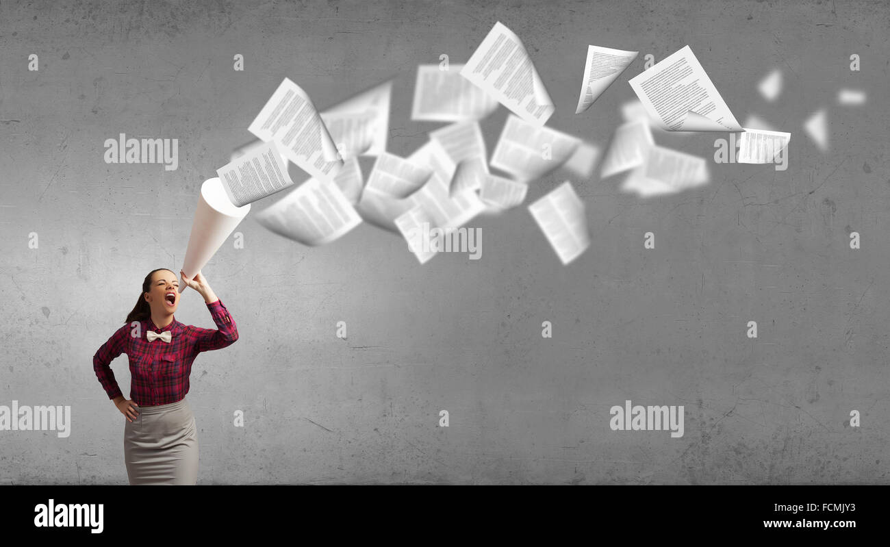 Young pretty woman screaming in paper trumpet Stock Photo - Alamy