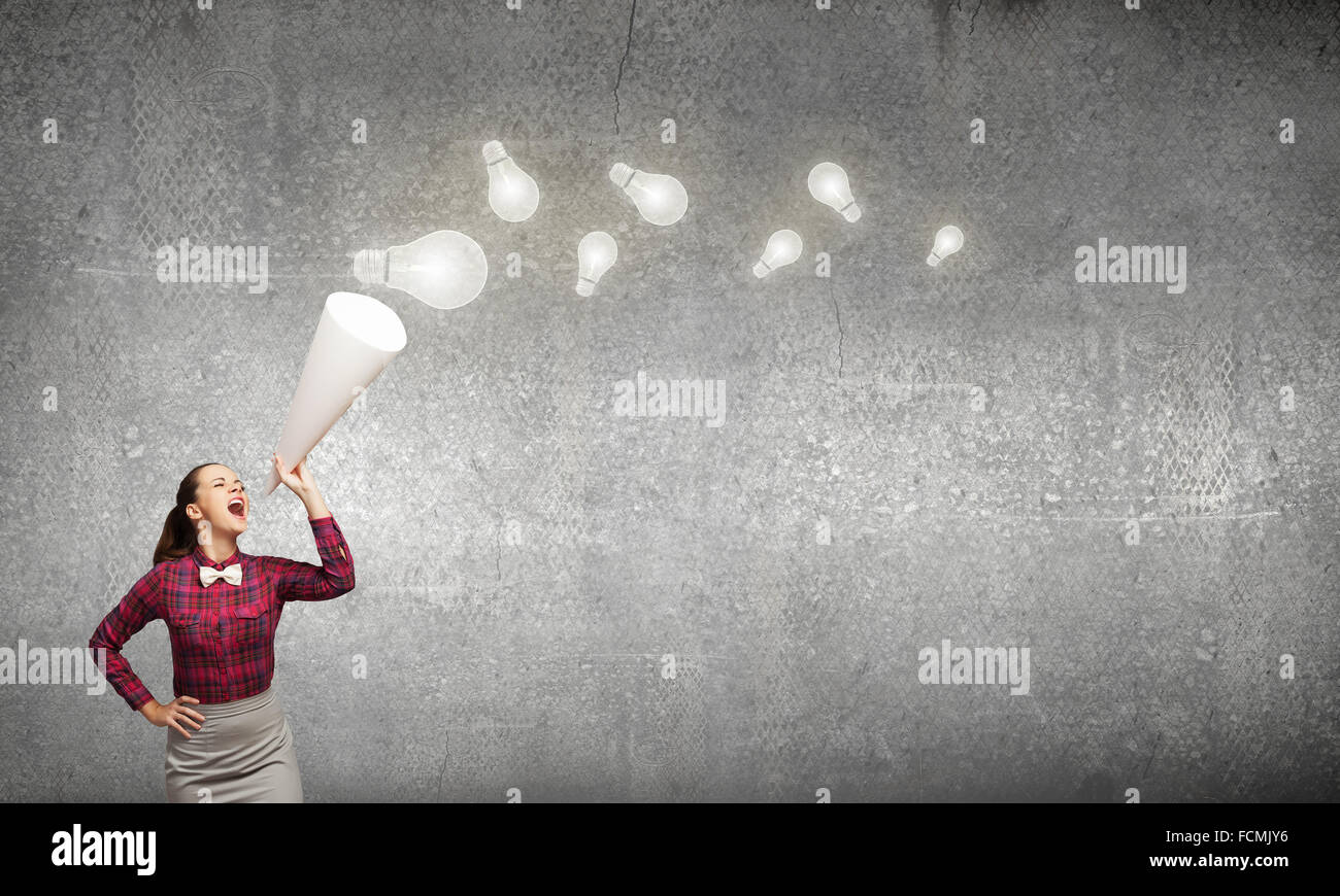 Young pretty woman screaming in paper trumpet Stock Photo - Alamy