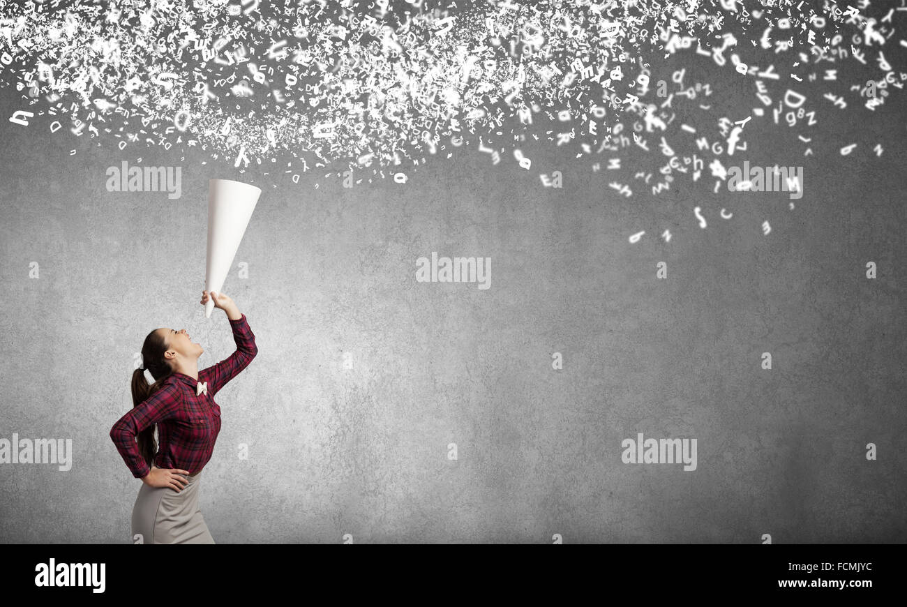 Young pretty woman screaming in paper trumpet Stock Photo - Alamy