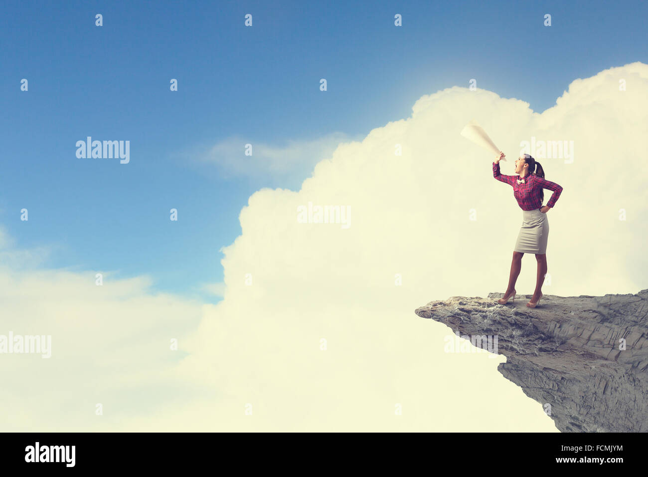 Young pretty woman screaming in paper trumpet Stock Photo - Alamy