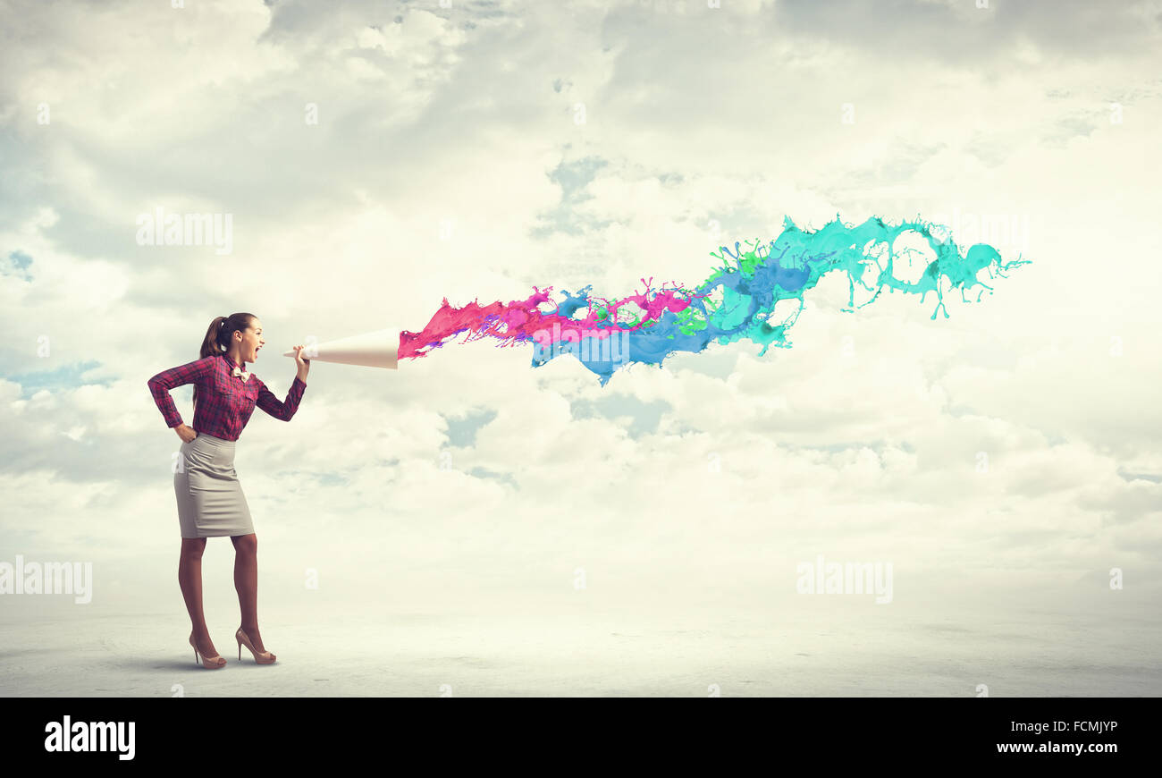 Young pretty woman screaming in paper trumpet Stock Photo - Alamy