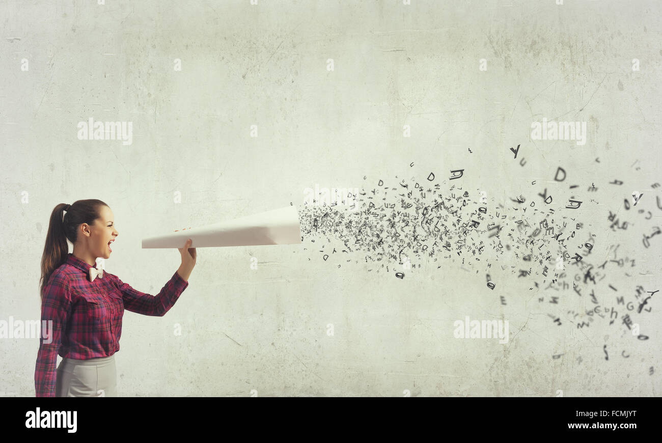 Young pretty woman screaming in paper trumpet Stock Photo - Alamy