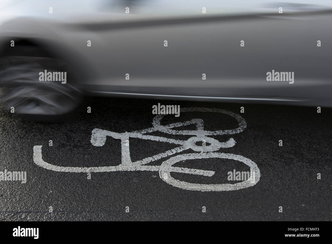 car in blurred motion travelling in marked cycle lane Stock Photo - Alamy