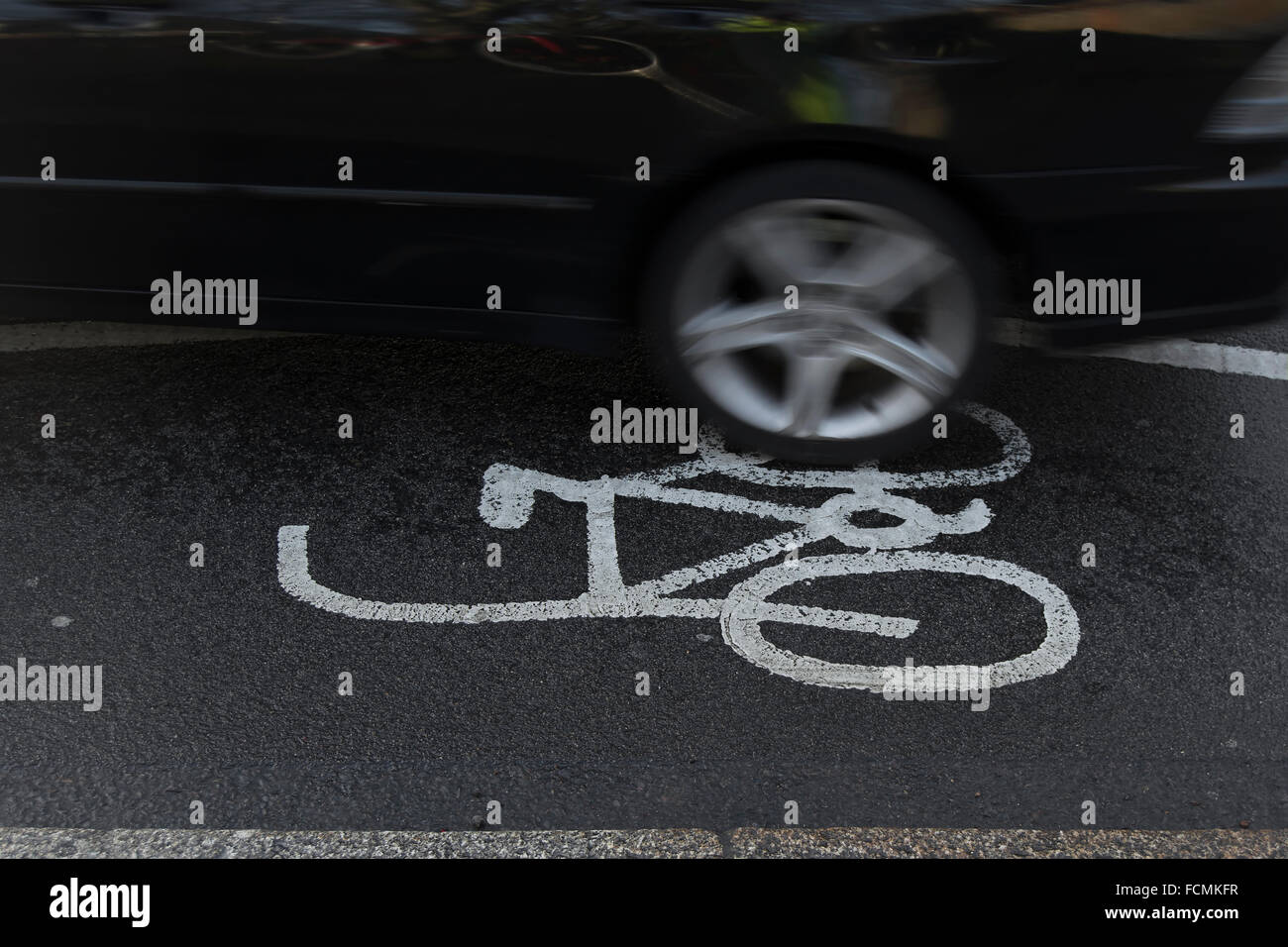 car in blurred motion travelling in marked cycle lane Stock Photo - Alamy