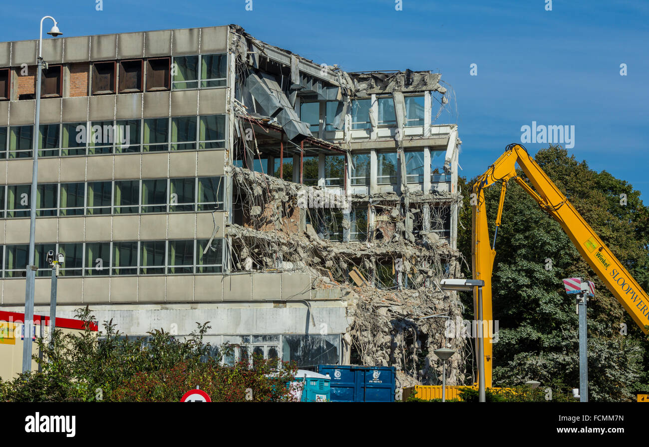 Demolition of a building by a high reach excavator Stock Photo - Alamy