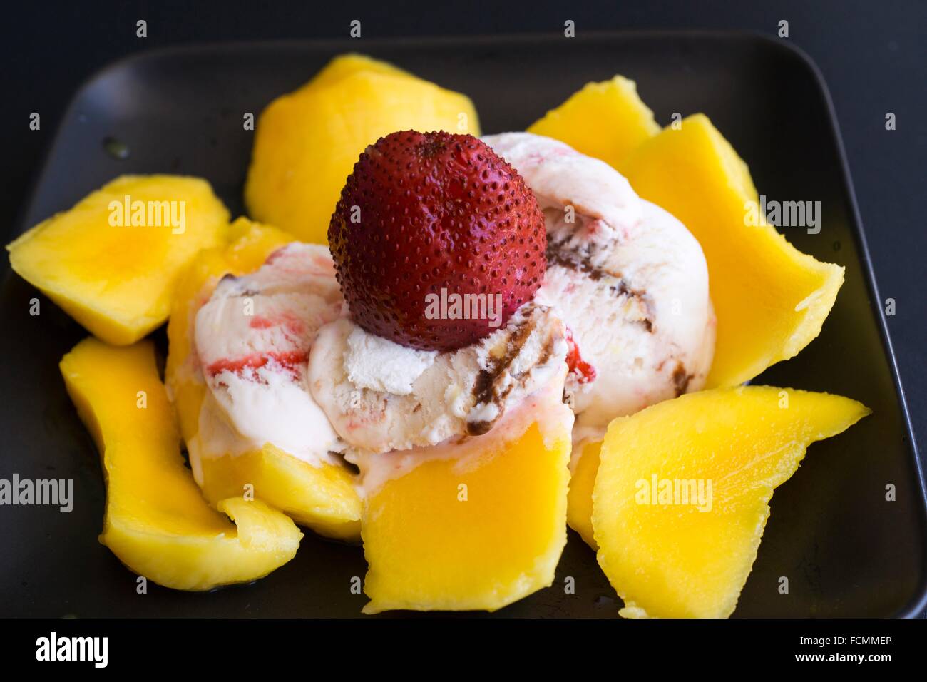Mango decadence' (ice cream on a bed of mango slices topped with a ...