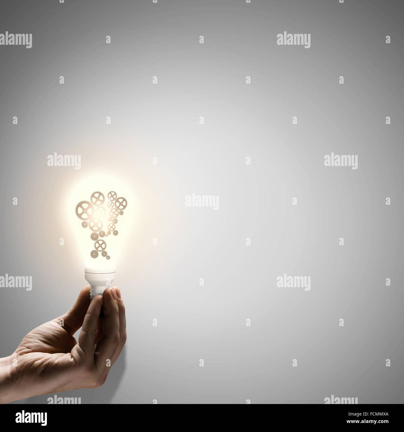 Close up of light bulb and gears mechanism Stock Photo - Alamy