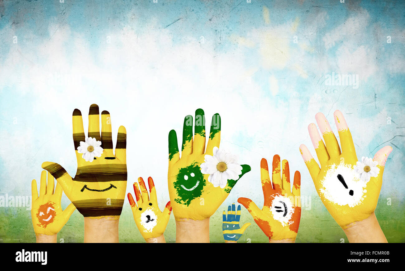 Human hands in colorful paint showing symbols Stock Photo - Alamy