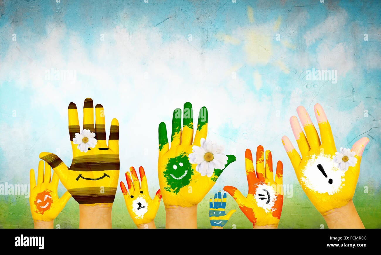 Human hands in colorful paint showing symbols Stock Photo - Alamy