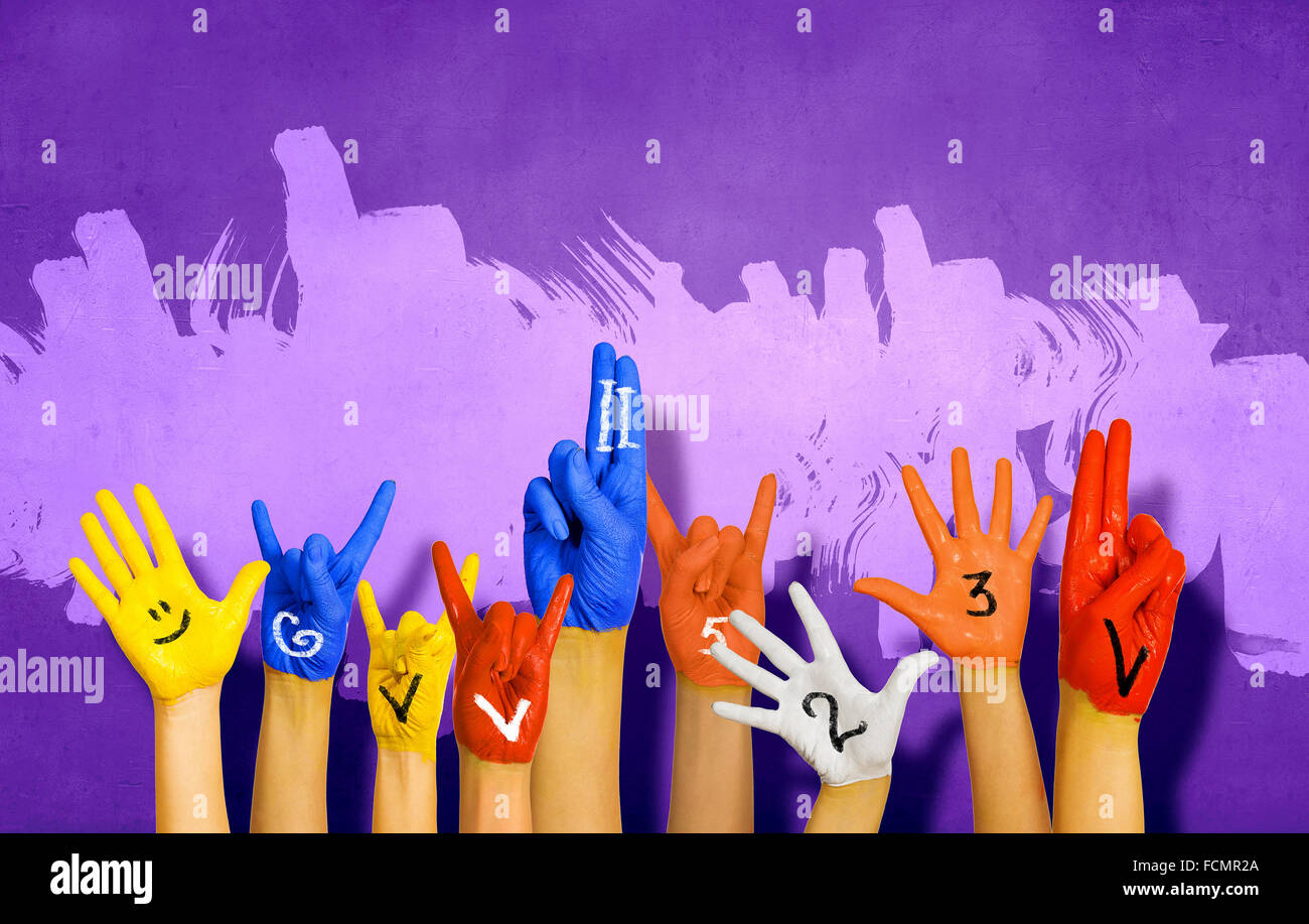 Human hands in colorful paint showing symbols Stock Photo - Alamy