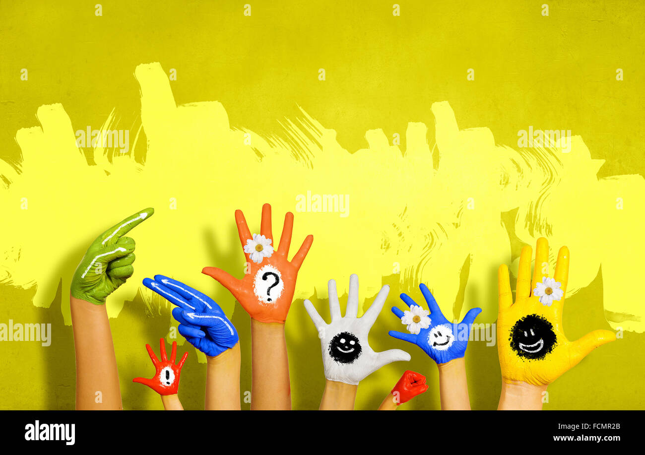Human hands in colorful paint showing symbols Stock Photo - Alamy