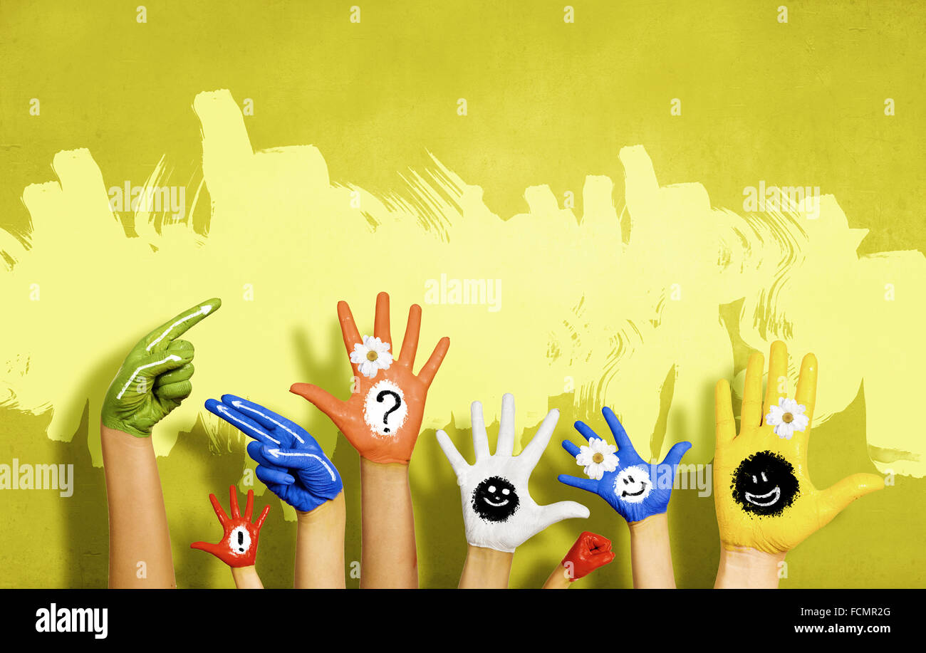 Human hands in colorful paint showing symbols Stock Photo - Alamy