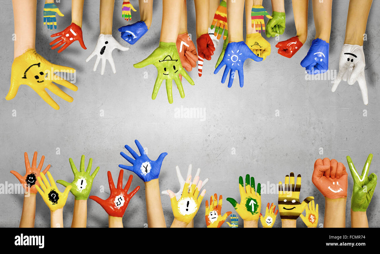 Human hands in colorful paint showing symbols Stock Photo - Alamy
