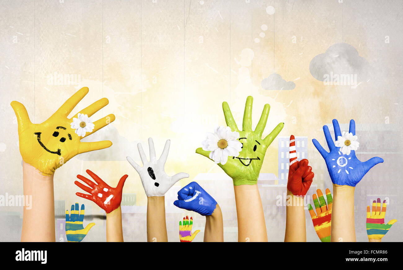 Human hands in colorful paint showing symbols Stock Photo - Alamy