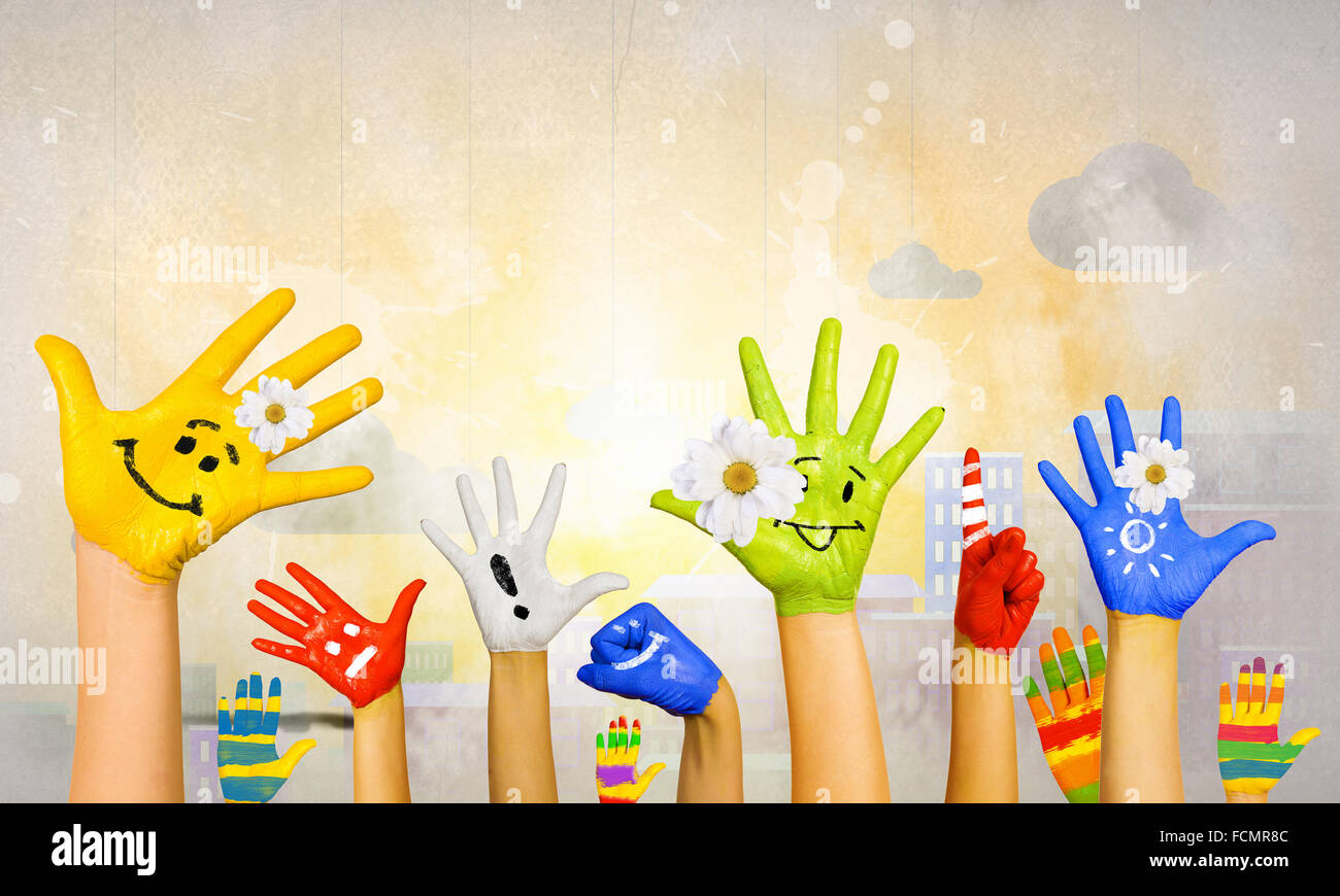 Human hands in colorful paint showing symbols Stock Photo - Alamy