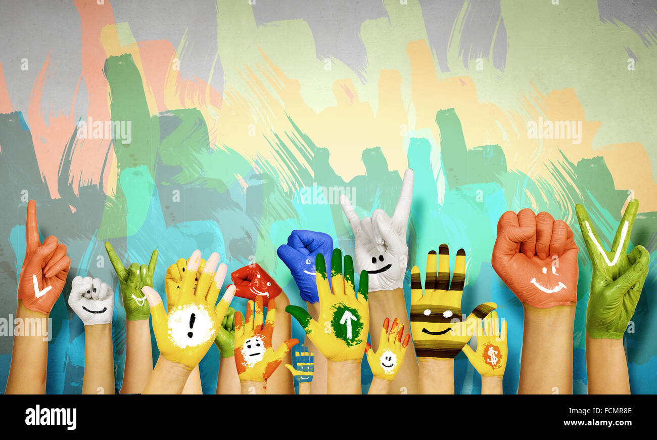Human hands in colorful paint showing symbols Stock Photo - Alamy