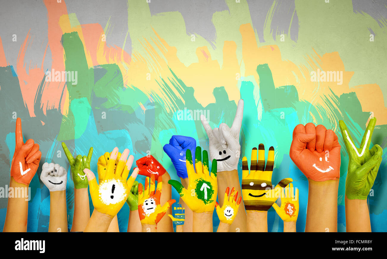 Human hands in colorful paint showing symbols Stock Photo - Alamy