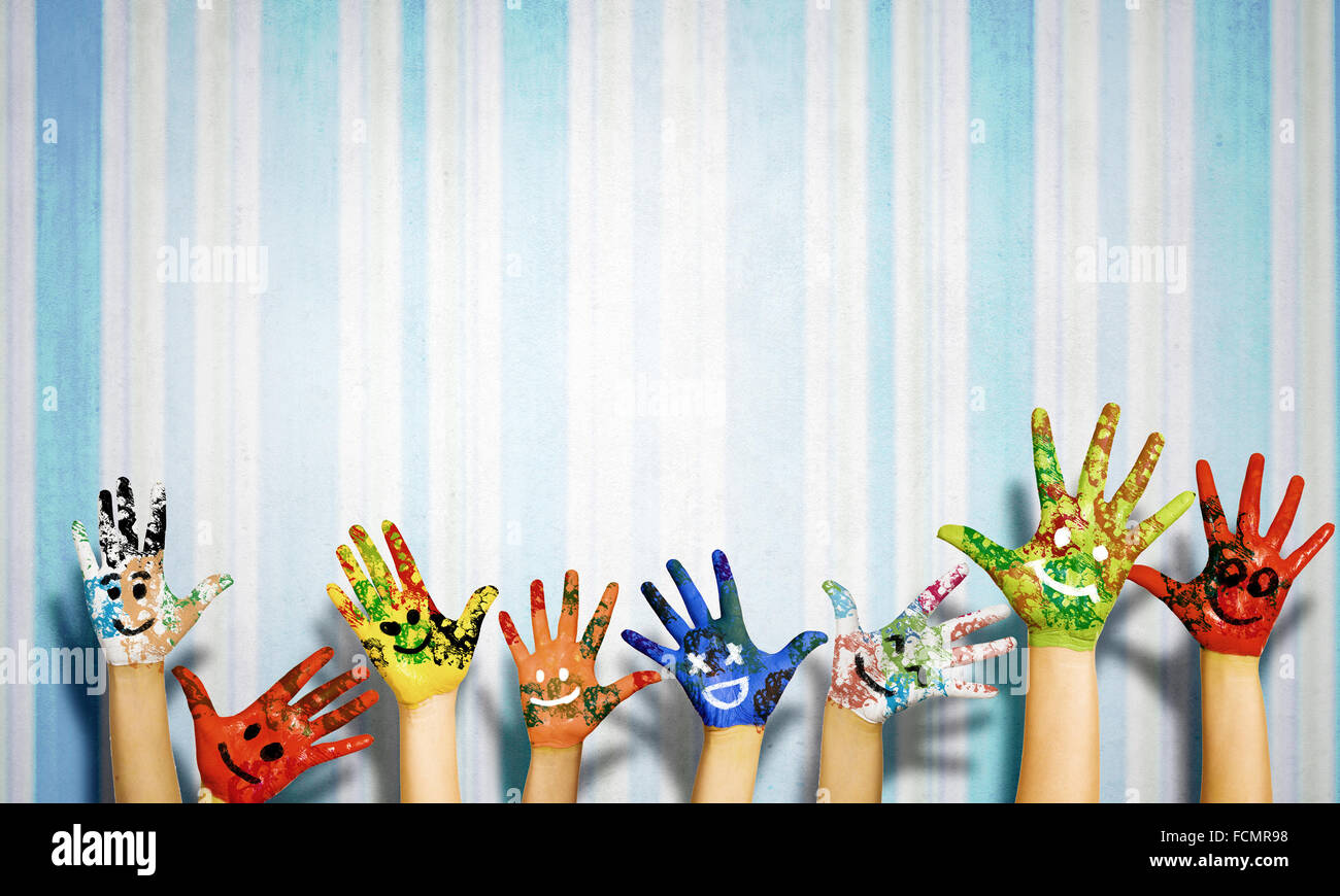 Human hands in colorful paint showing symbols Stock Photo - Alamy