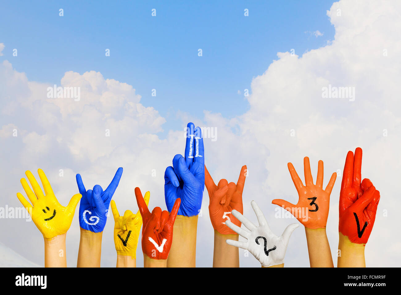 Human hands in colorful paint showing symbols Stock Photo - Alamy