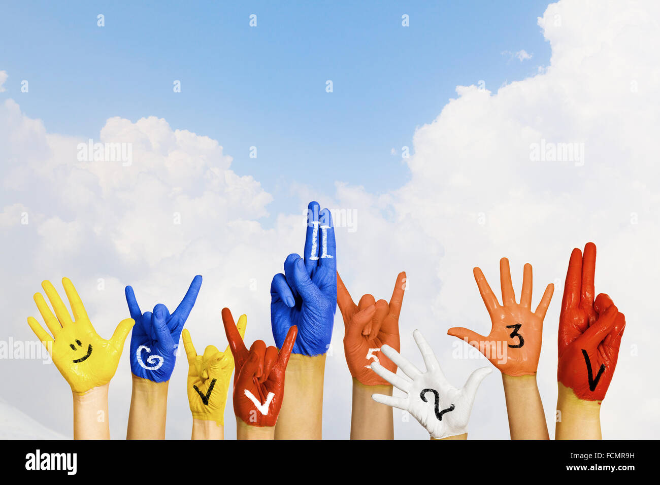 Human hands in colorful paint showing symbols Stock Photo - Alamy
