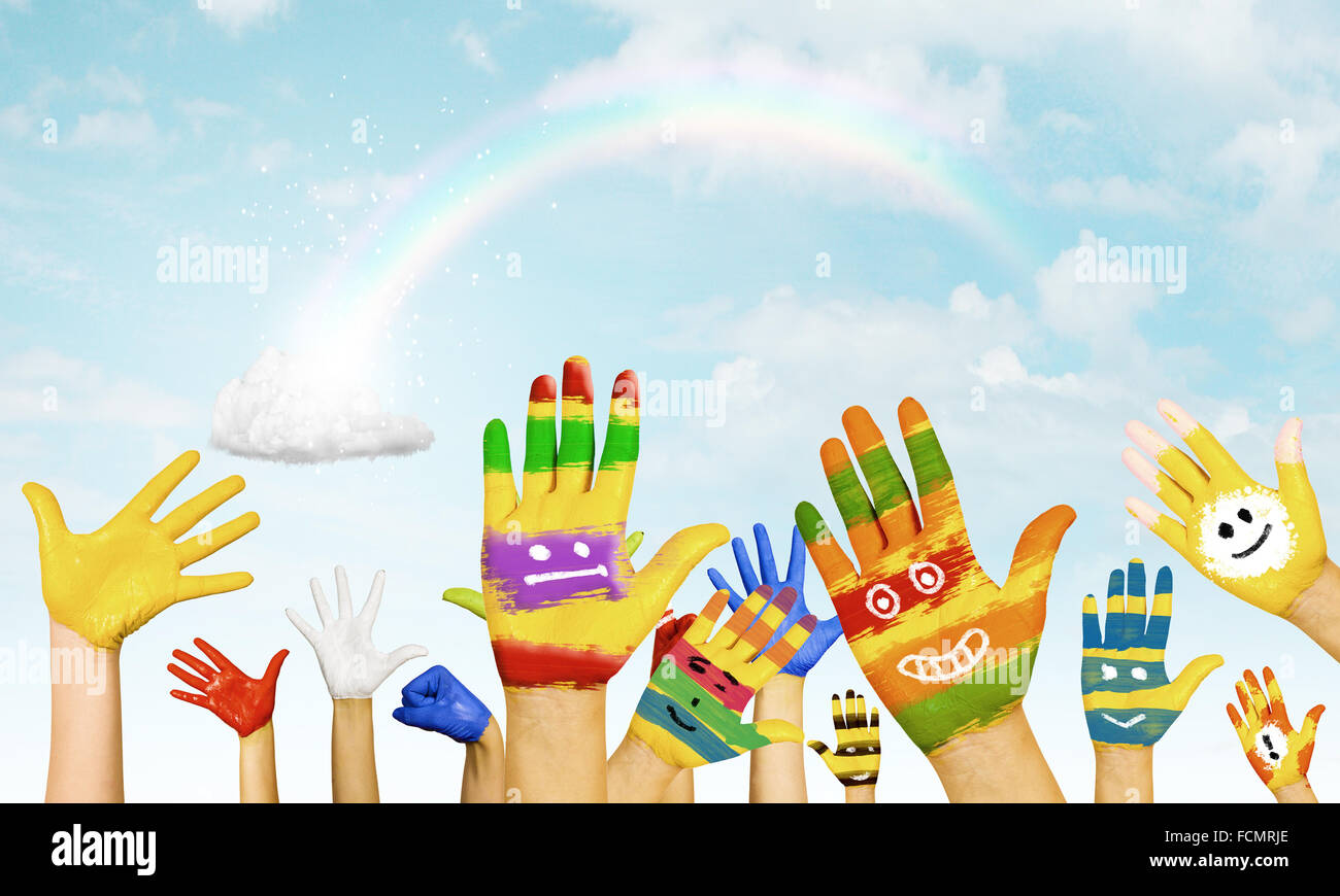 Human hands in colorful paint showing symbols Stock Photo - Alamy