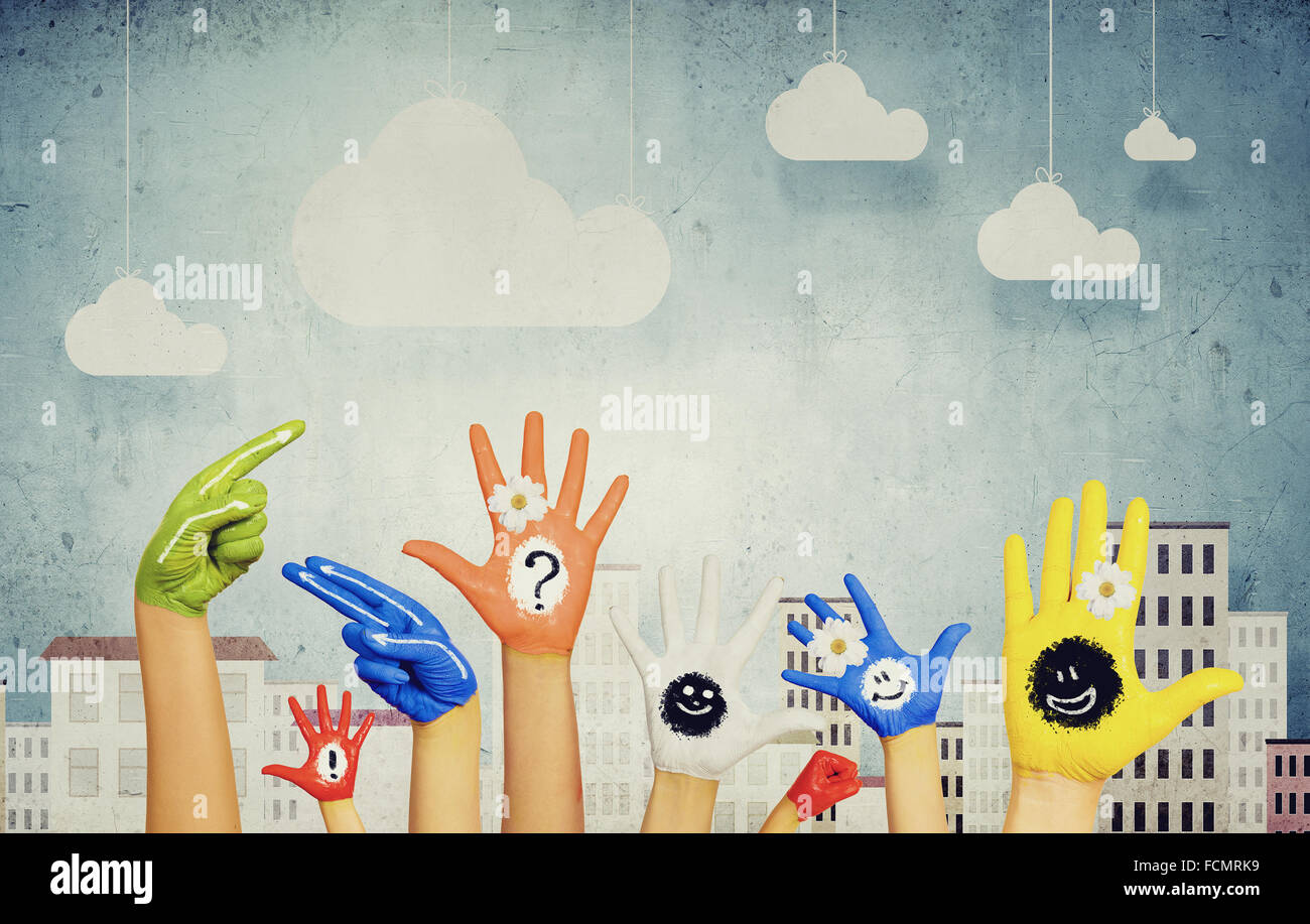 Human hands in colorful paint showing symbols Stock Photo - Alamy