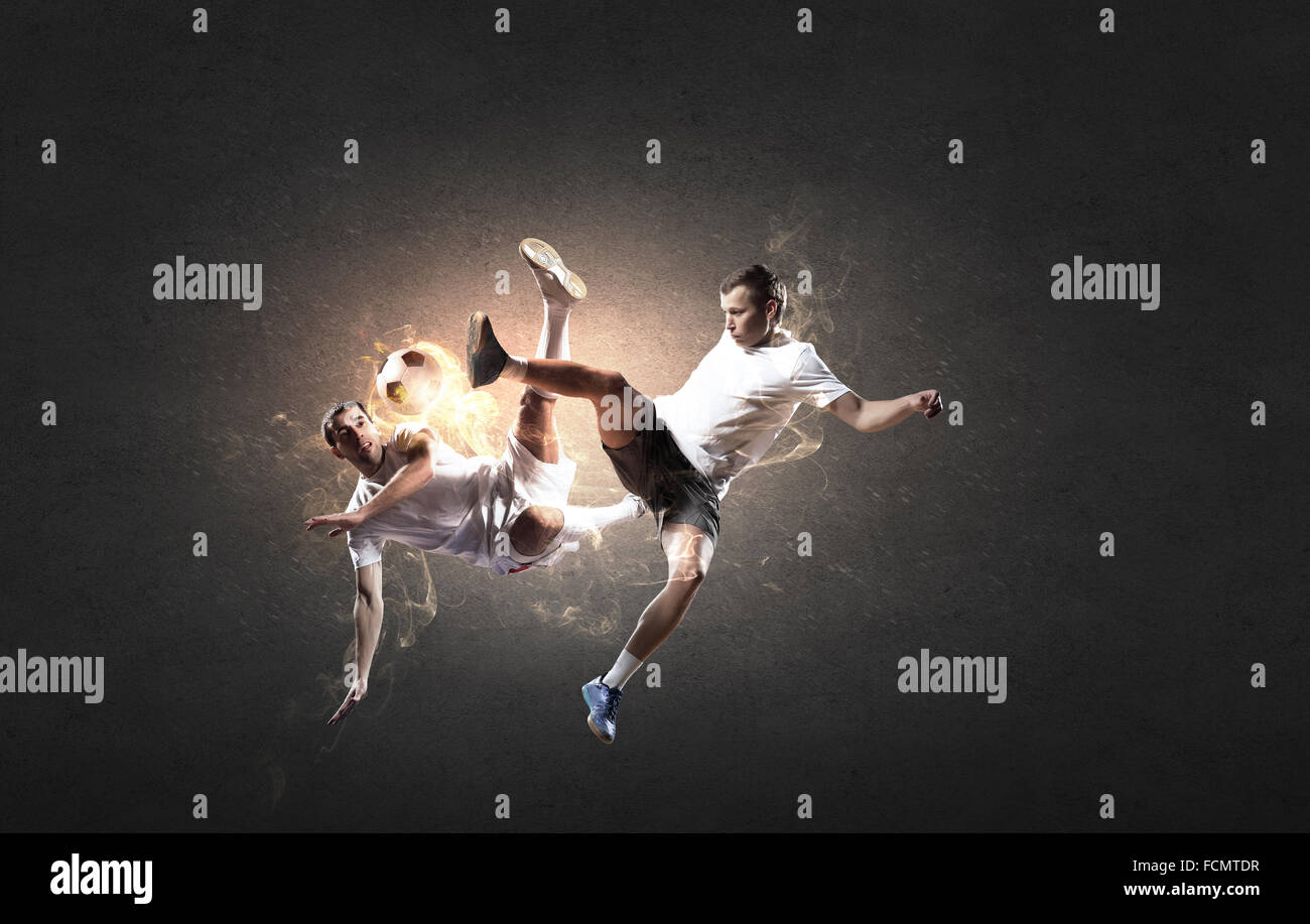 Two football players in jump fighting for ball Stock Photo - Alamy
