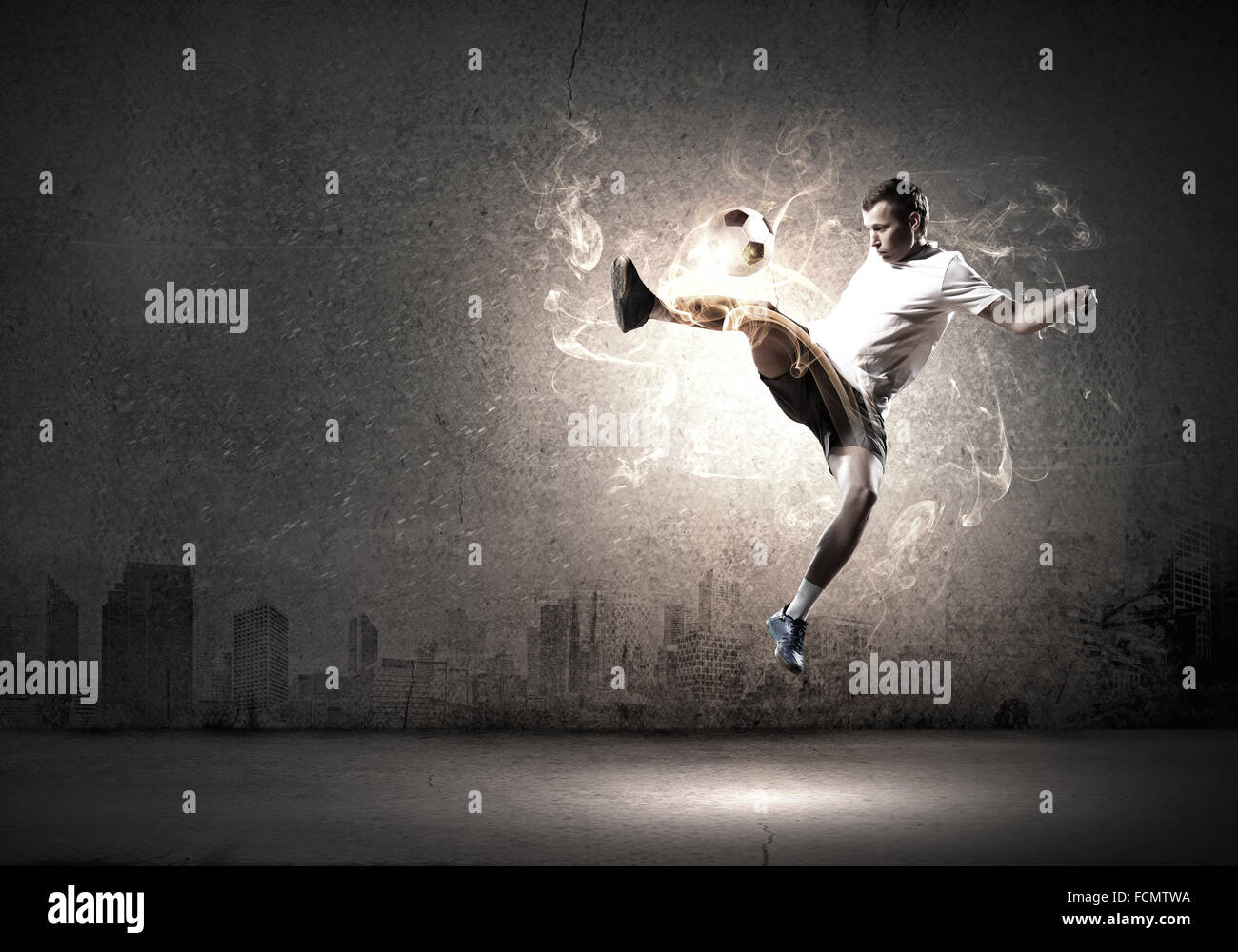 Football player in high jump taking ball Stock Photo - Alamy