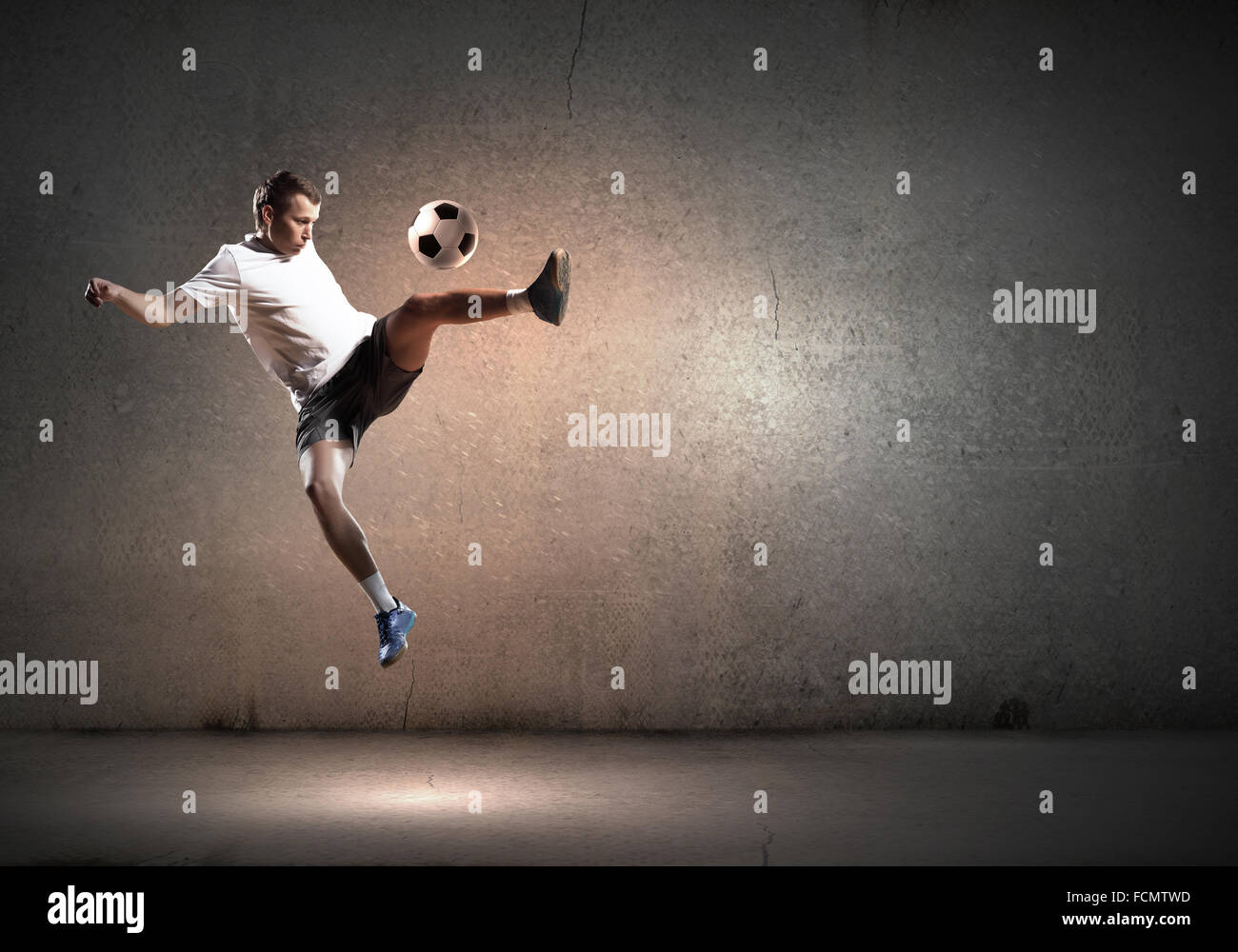Football player in high jump taking ball Stock Photo - Alamy
