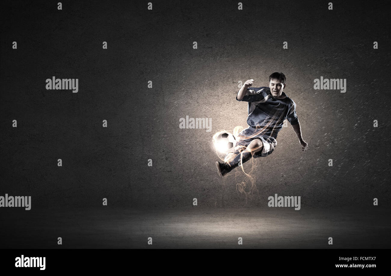 Football player in high jump taking ball Stock Photo - Alamy